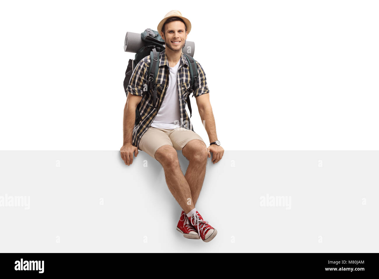 Tourist sitting on a panel and looking at the camera isolated on white ...