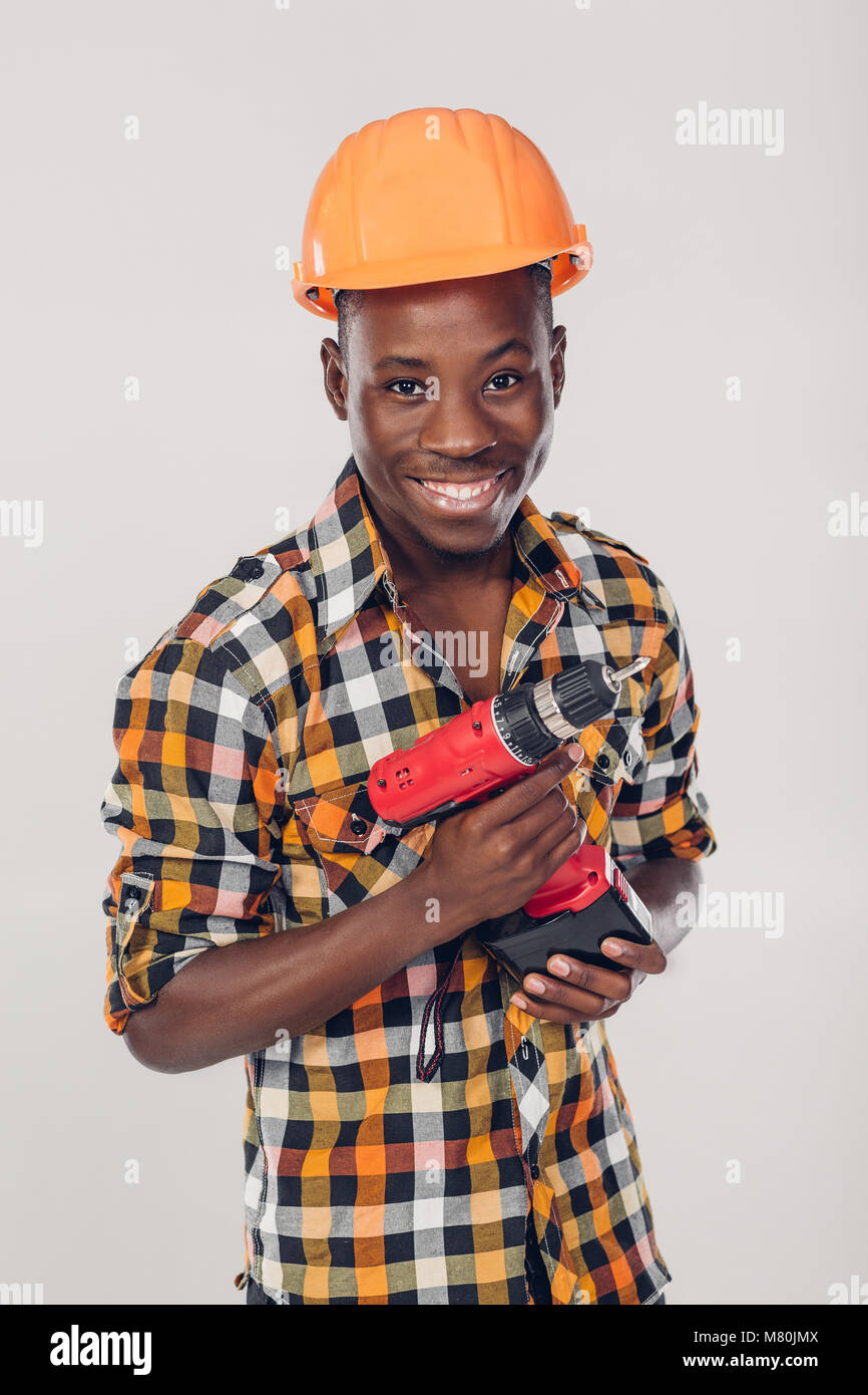 African American worker uses electric screwdriver Stock Photo - Alamy
