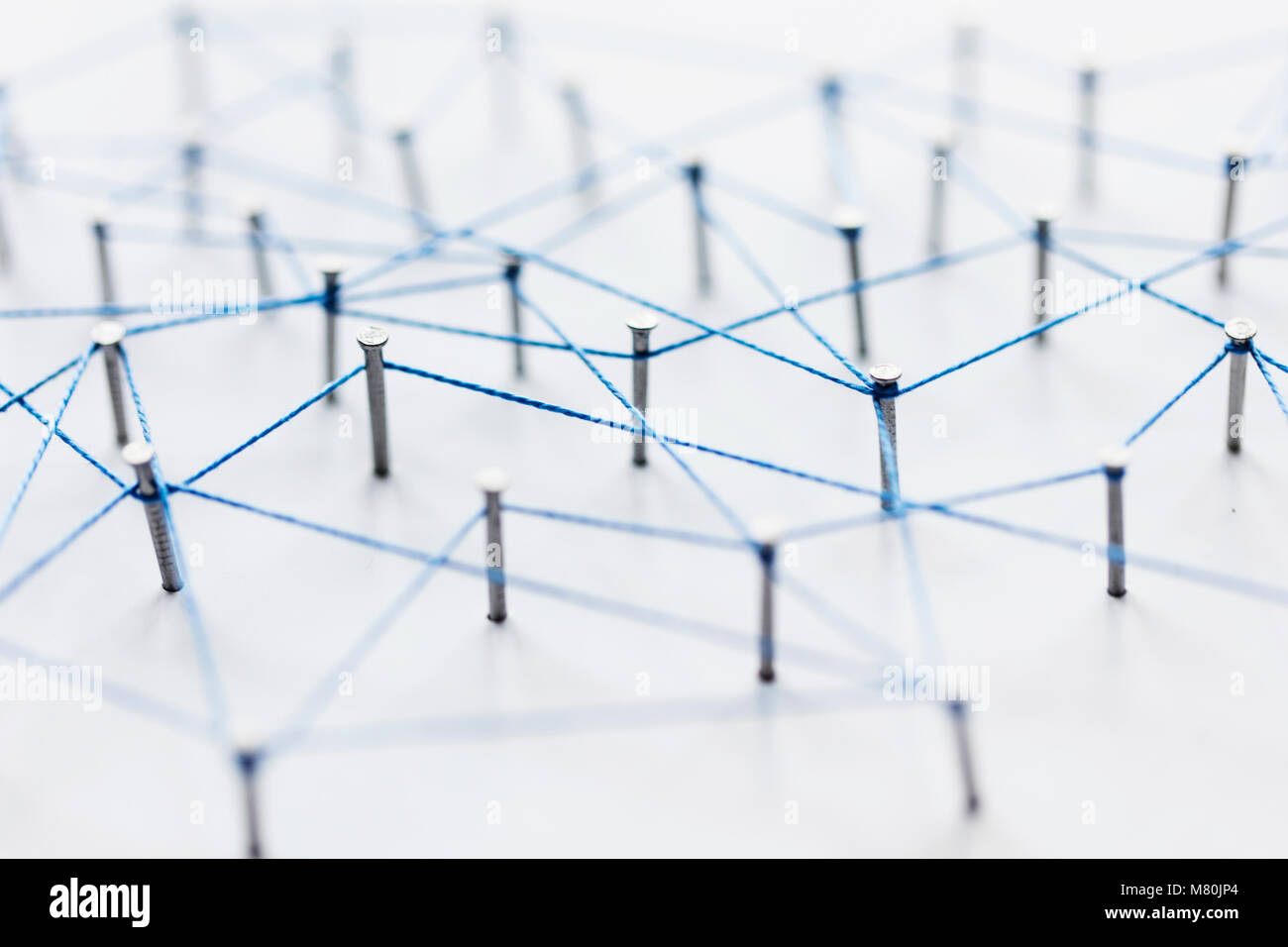 A large grid of pins connected with string. Communication, technology ...