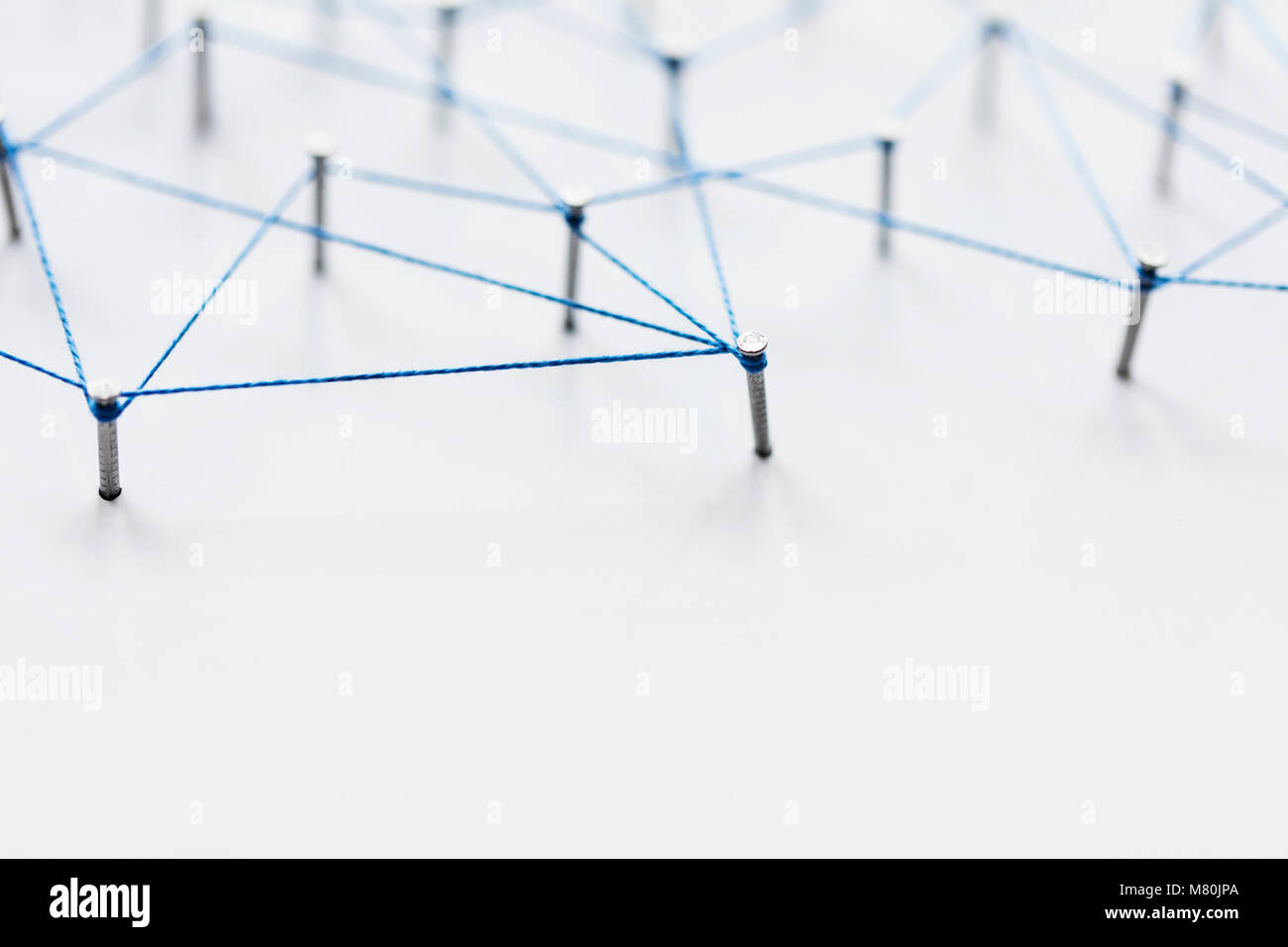 A large grid of pins connected with string. Communication, technology ...