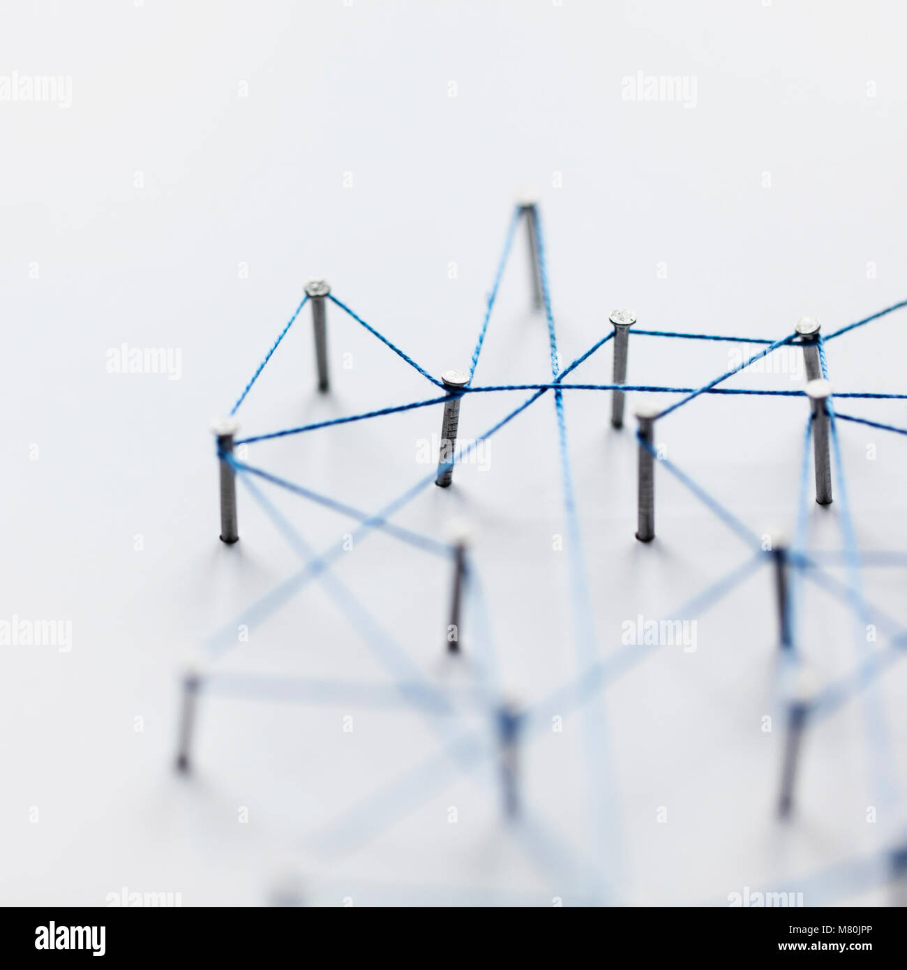 A large grid of pins connected with string. Communication, technology ...