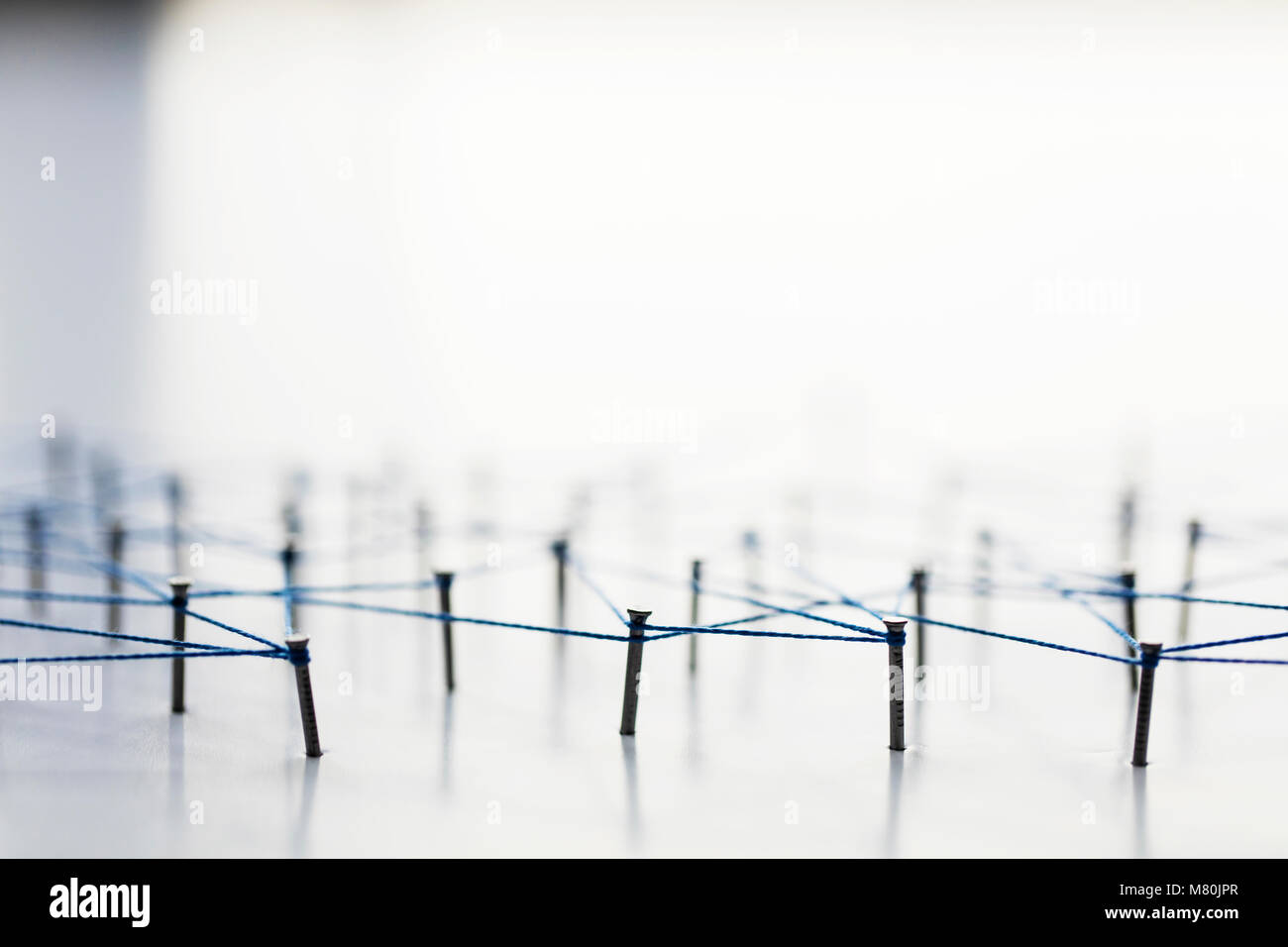 A large grid of pins connected with string. Communication, technology ...