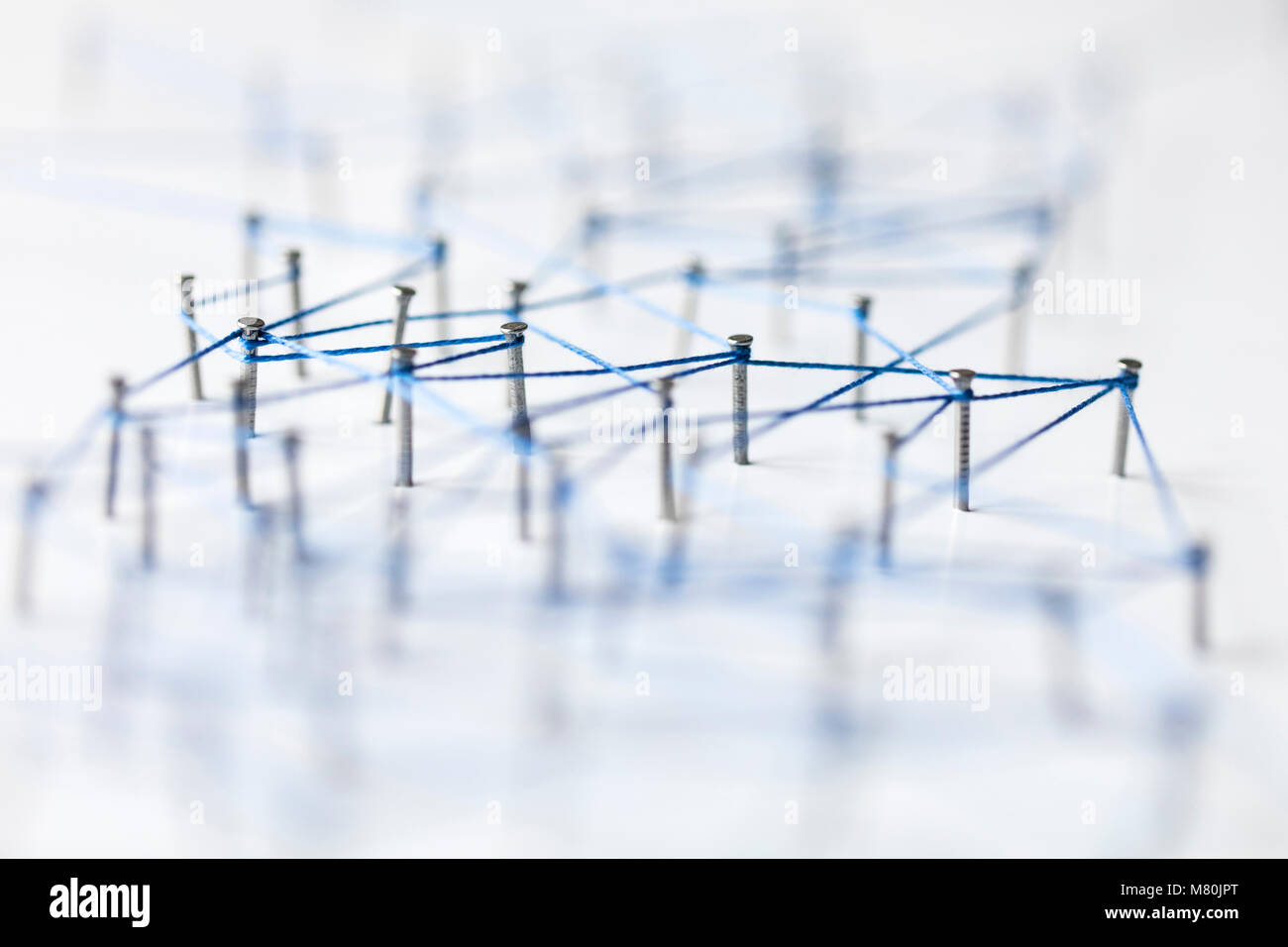 A large grid of pins connected with string. Communication, technology ...