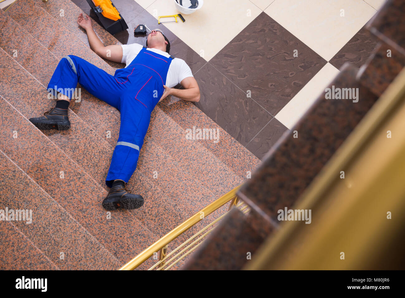 Dead contractor worker felling off the stairs Stock Photo - Alamy
