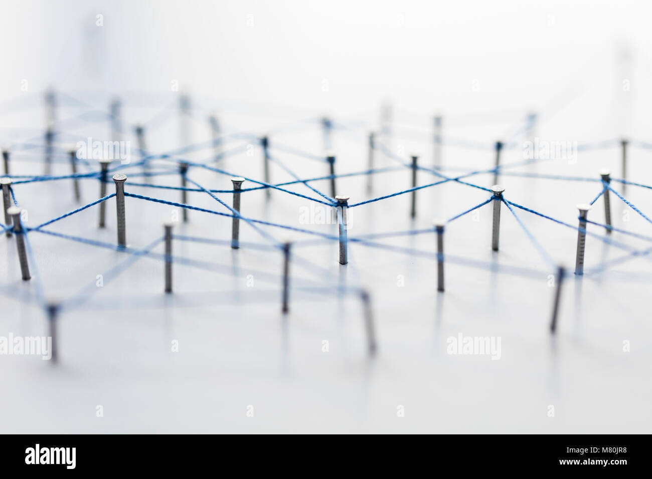 A large grid of pins connected with string. Communication, technology ...