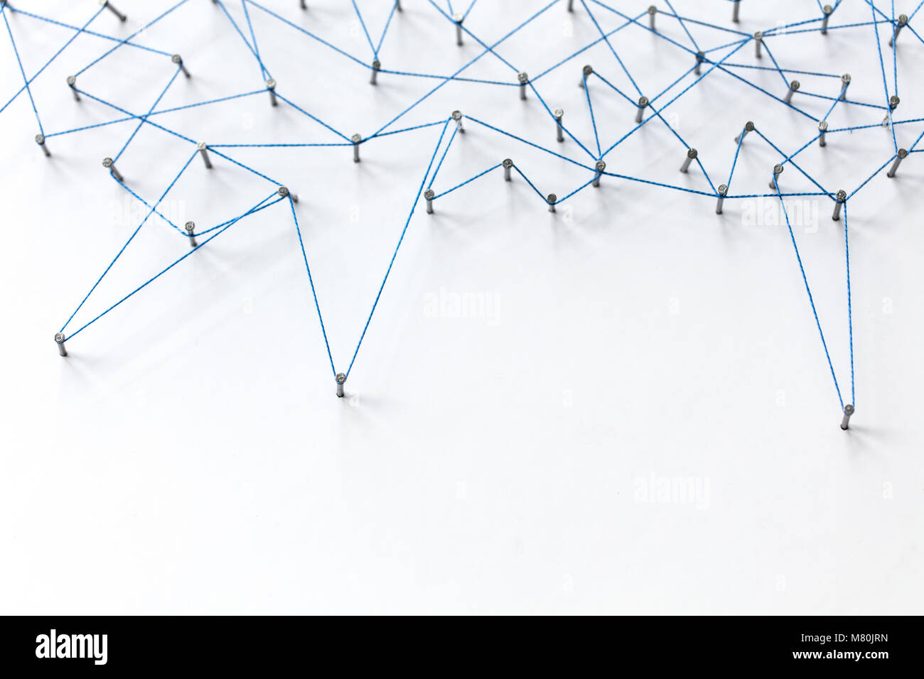 A large grid of pins connected with string. Communication, technology ...