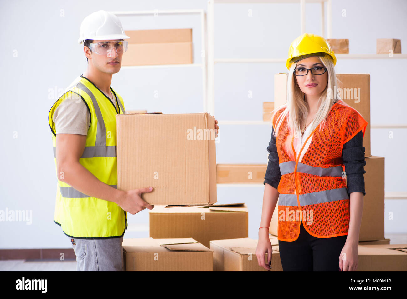 Delivery contractor delivering boxes to office Stock Photo - Alamy