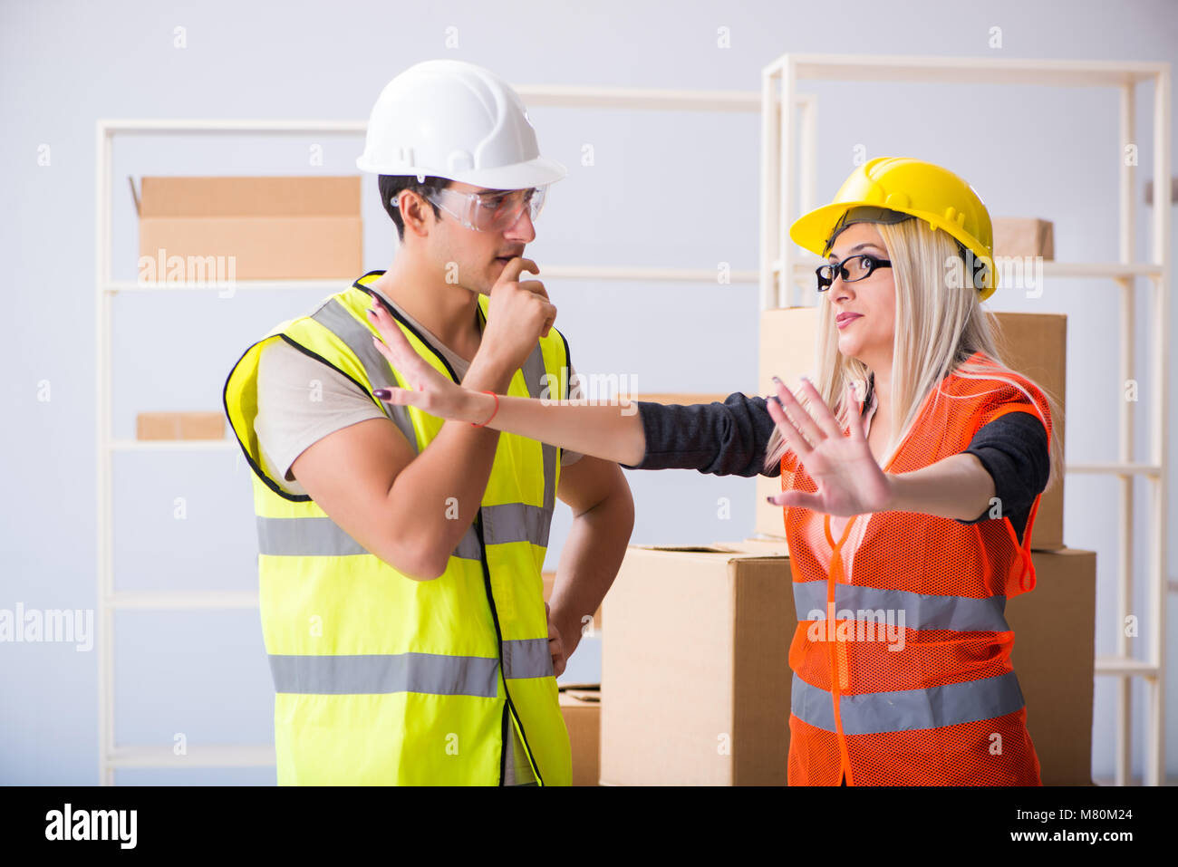 Delivery contractor delivering boxes to office Stock Photo - Alamy