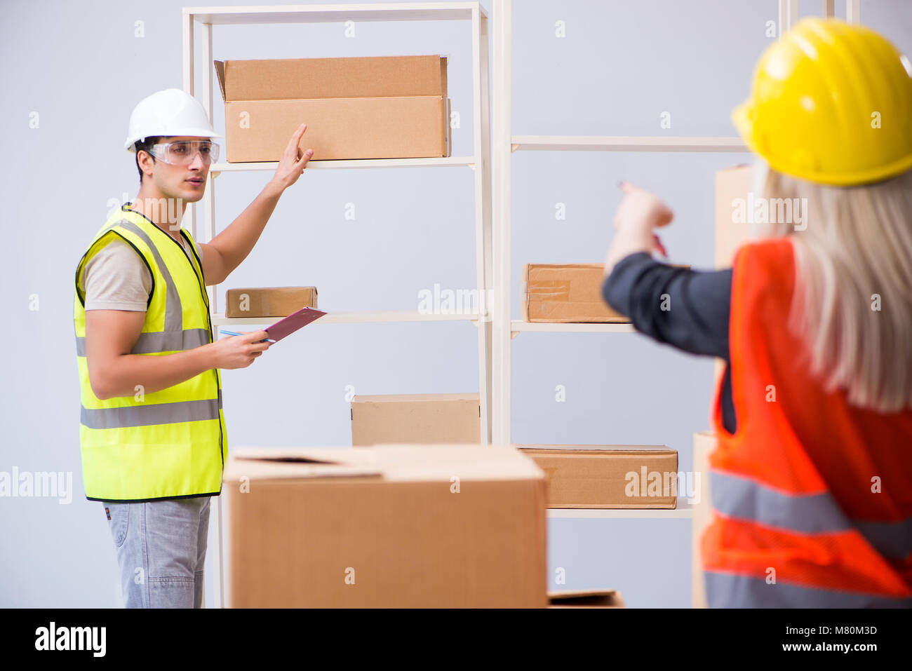 Delivery contractor delivering boxes to office Stock Photo - Alamy