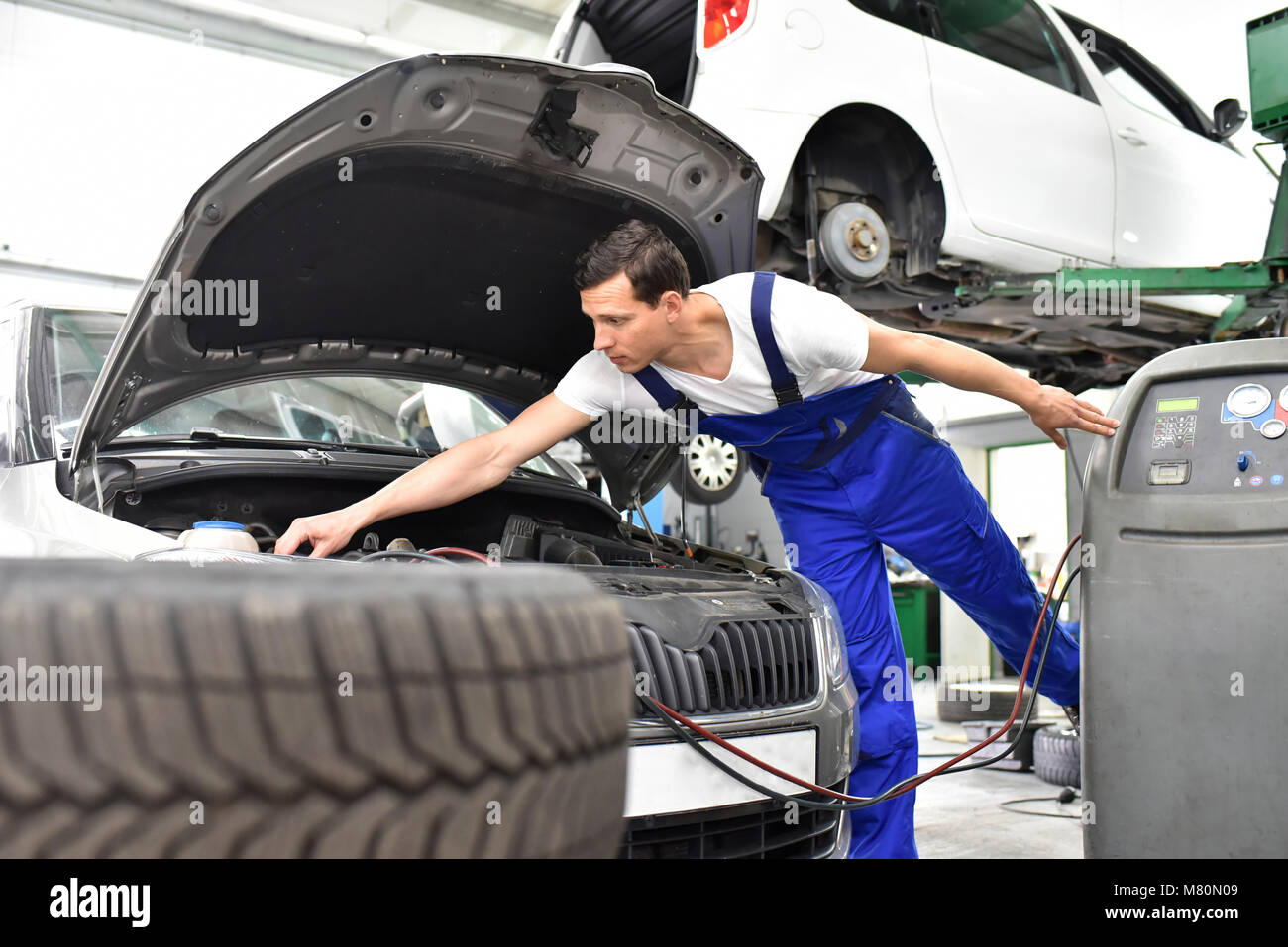car mechanic works in a workshop, repair of cars Stock Photo - Alamy