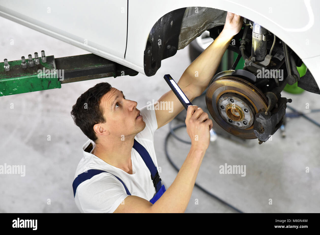 car mechanic works in a workshop, repair of cars Stock Photo - Alamy