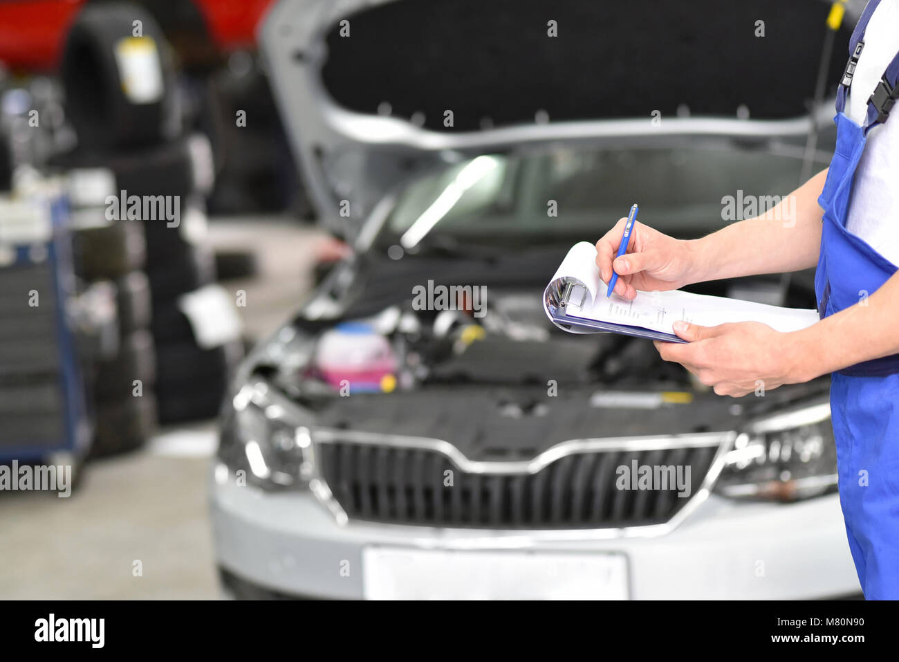 service and inspection of a car in a workshop - mechanic inspects the ...