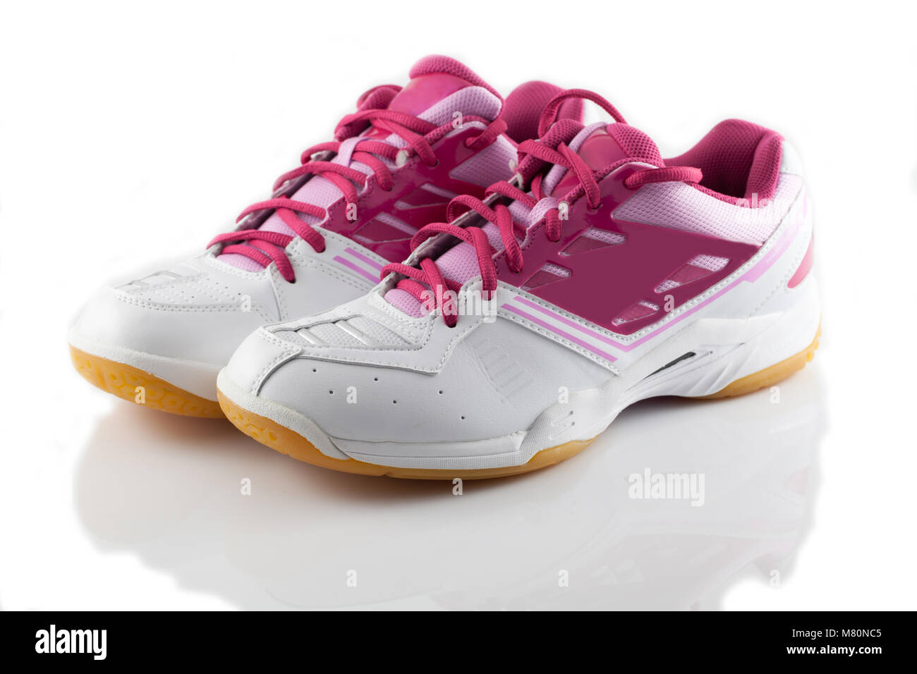 Badminton shoes on pink color isolate Stock Photo - Alamy