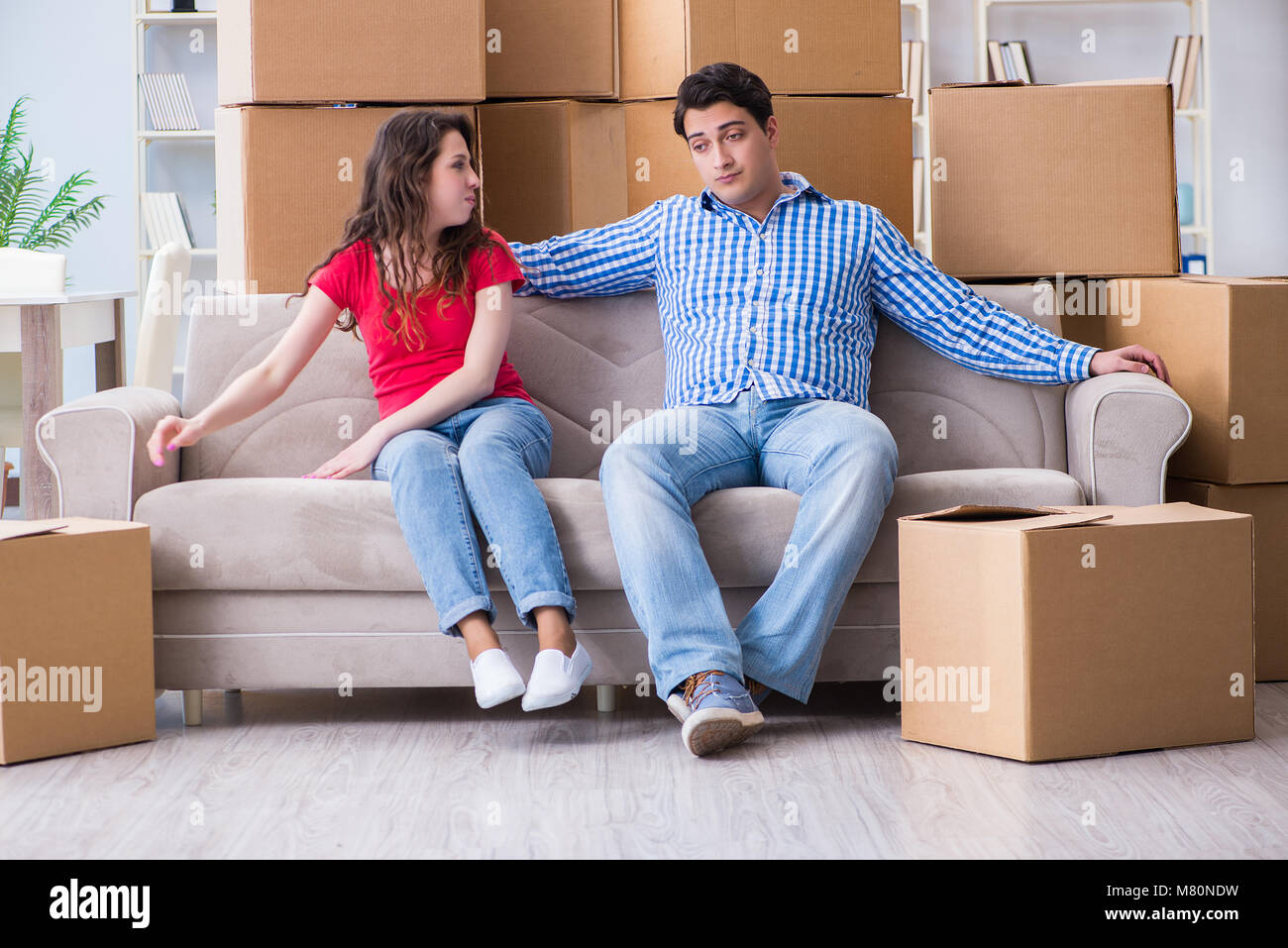 Young pair moving in to new house with boxes Stock Photo - Alamy