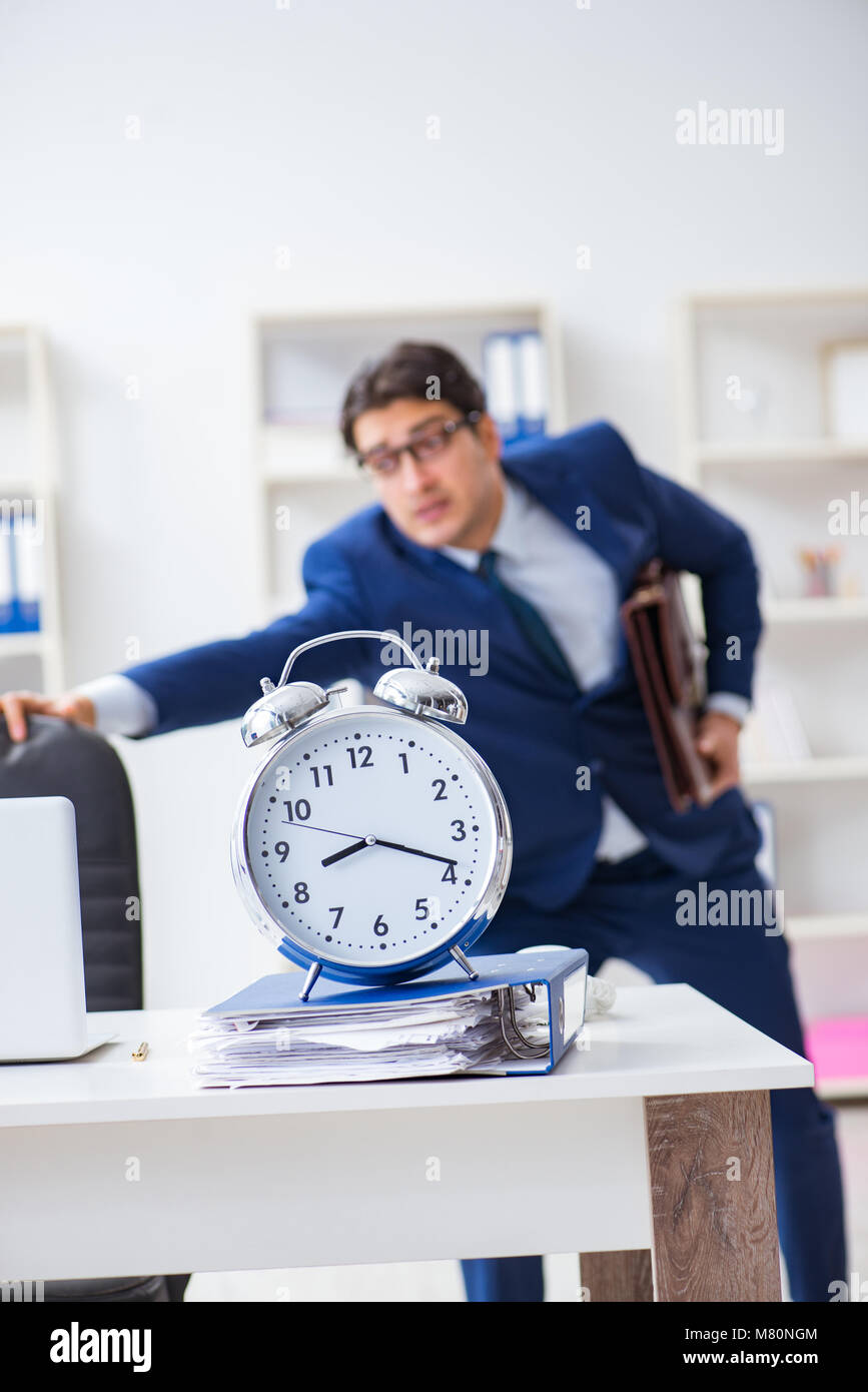 Businessman in bad time management concept Stock Photo - Alamy