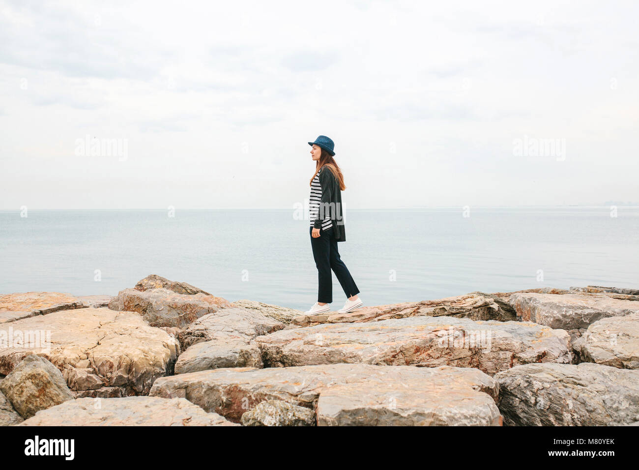 A traveler in a hat walks by the sea. Travel, tourism Stock Photo - Alamy