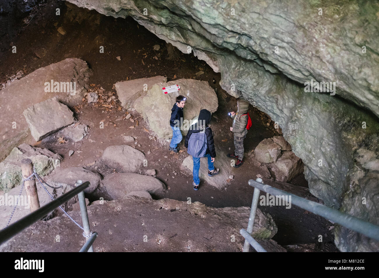 children explore underground caves, with electric torches exploring the ...