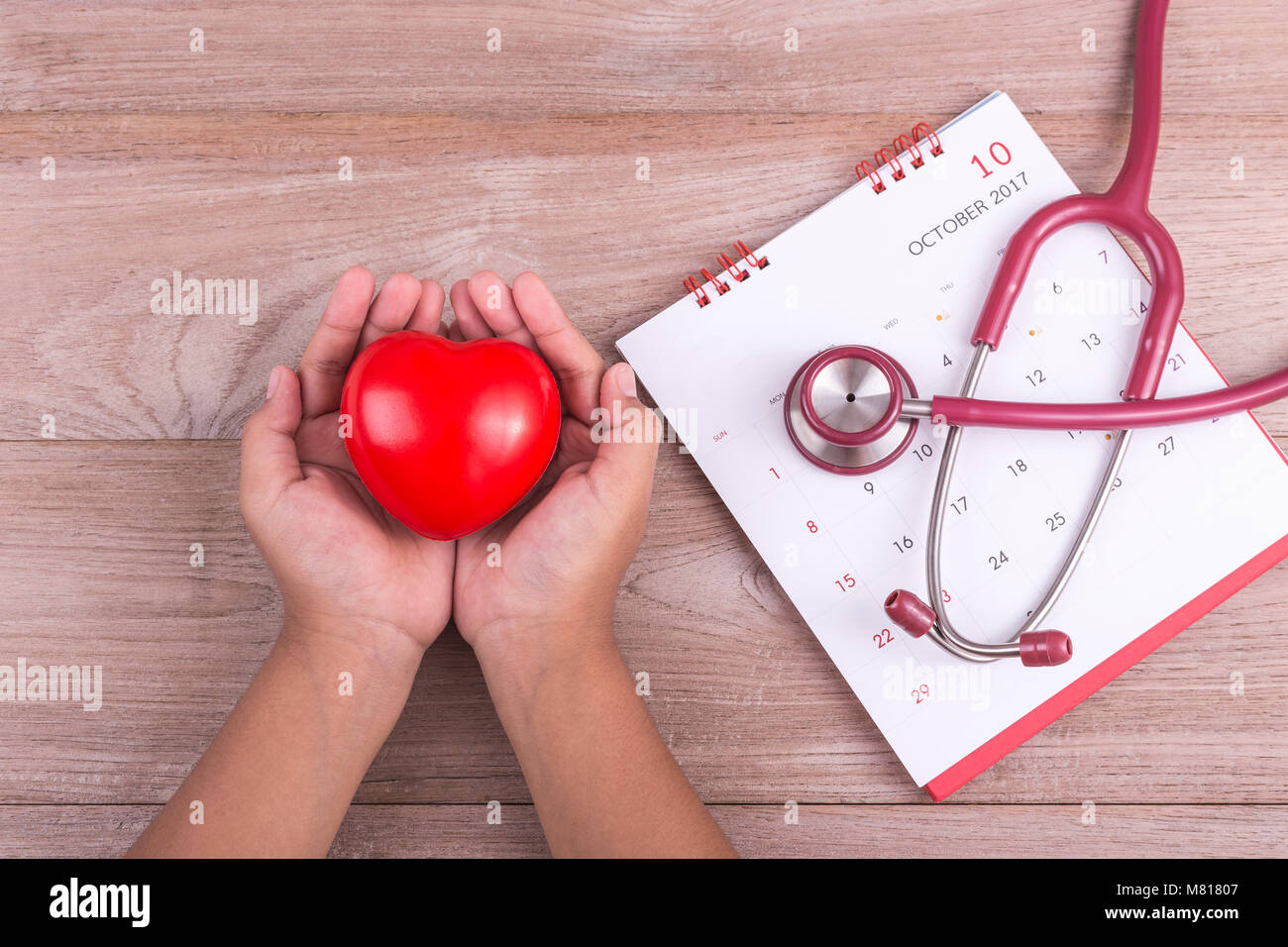 Check heart Concept : Woman hands holding red heart and stethoscope on ...