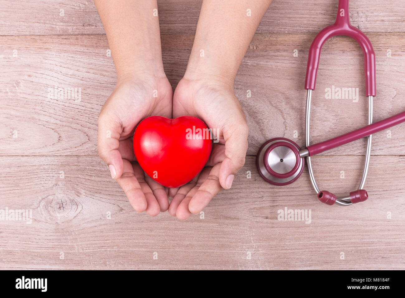 Check heart Concept : Woman hands holding red heart and stethoscope on ...