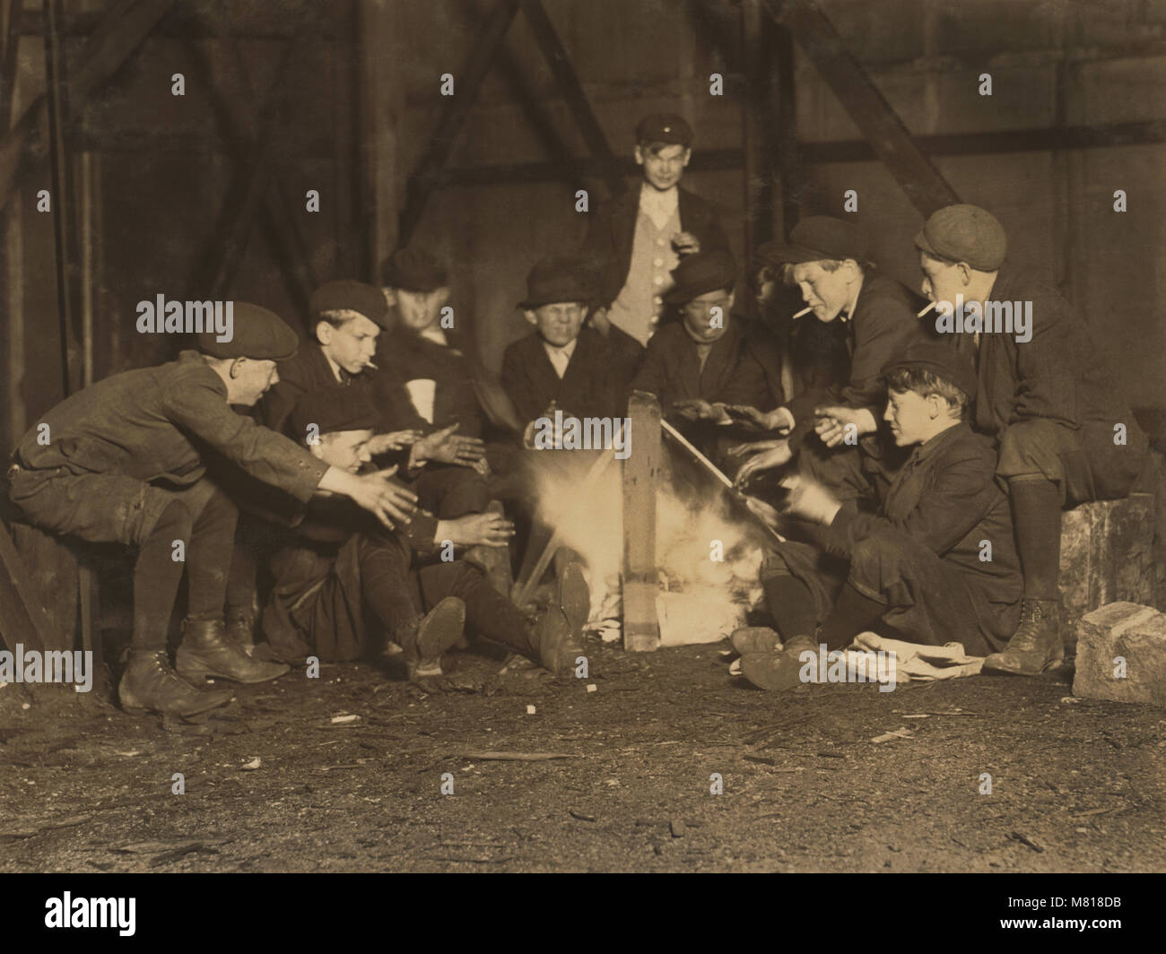 Gang of Newsboys Staying Warm over Campfire in Corner Lot at Night ...