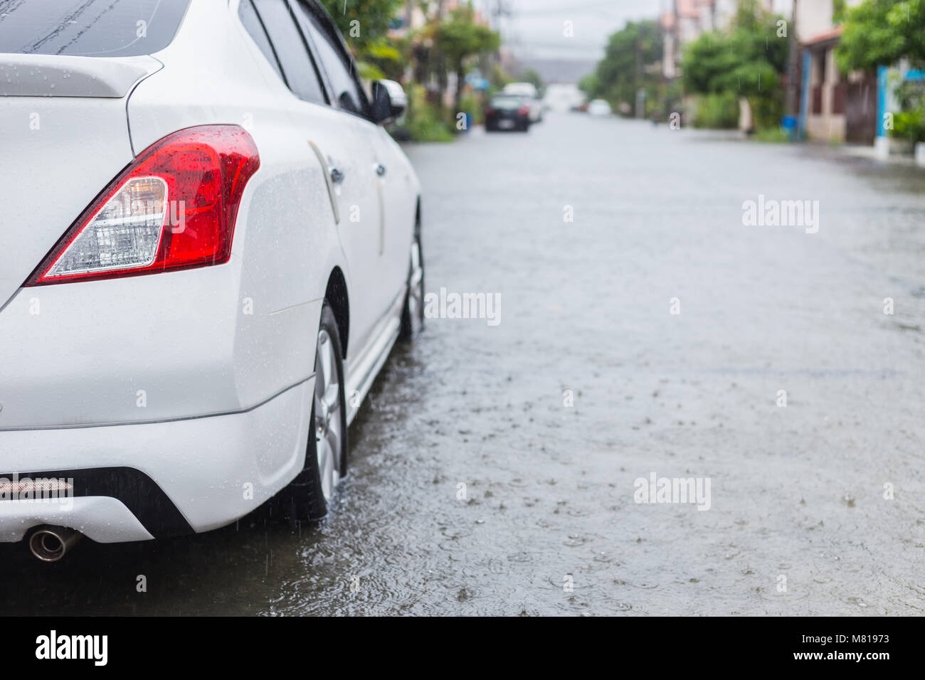 Car parking on the street of village while raining and show level of ...