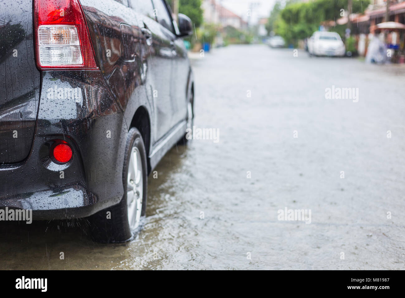 Car parking on the street of village while raining and show level of ...