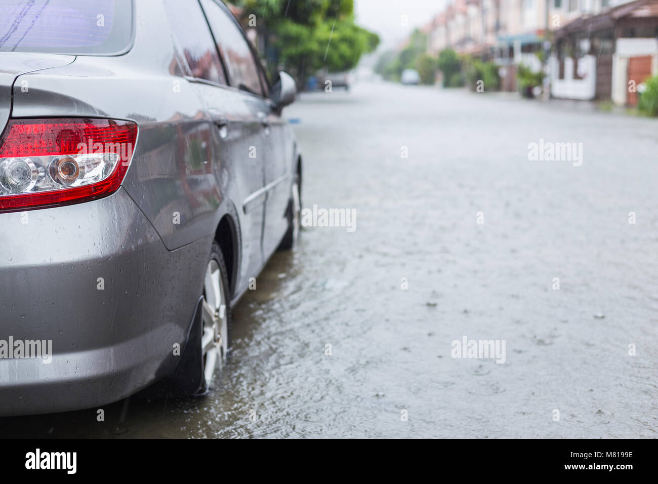 Car parking on the street of village while raining and show level of ...