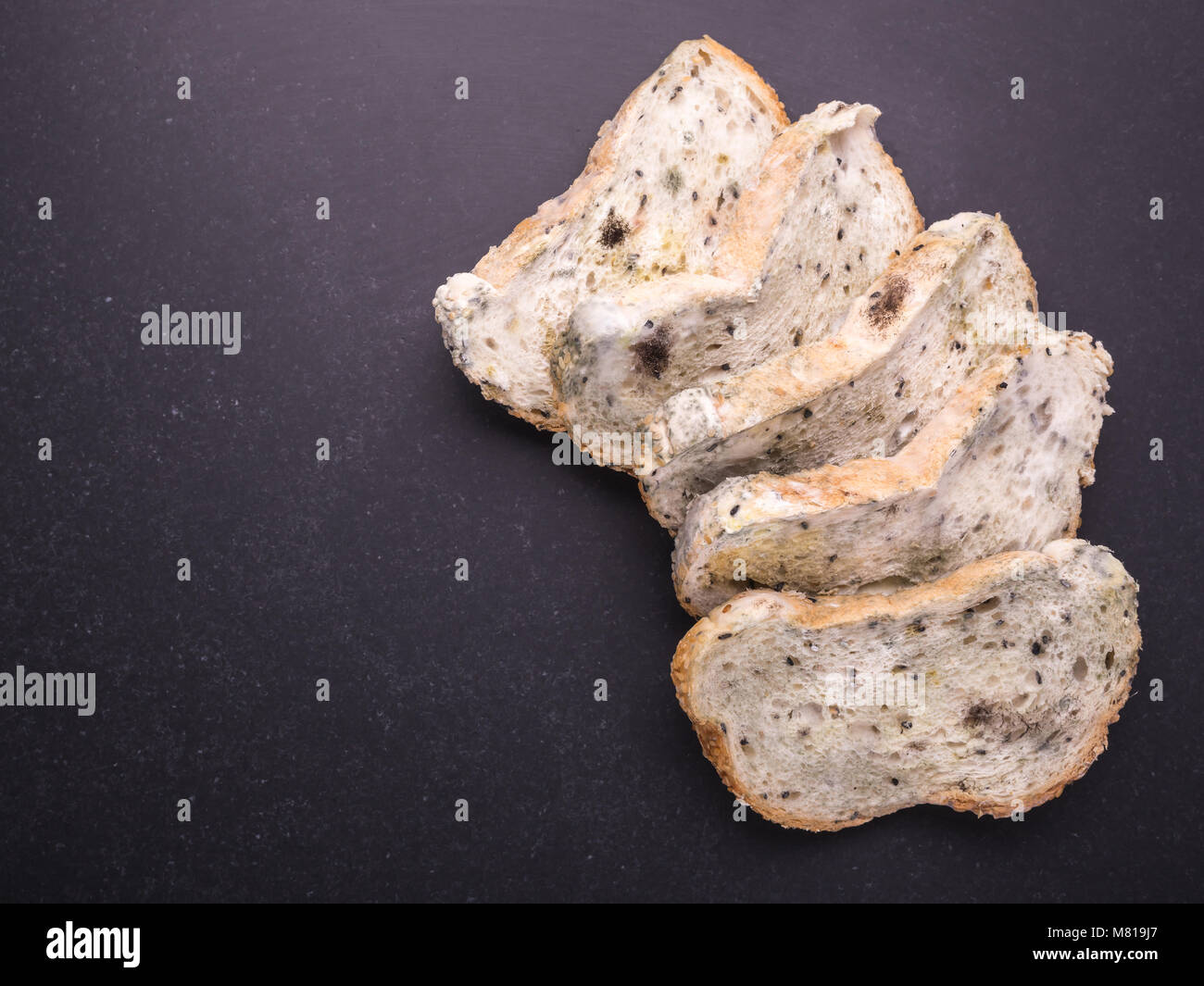 Mold on bread put on black stone table background. Top view Stock Photo ...