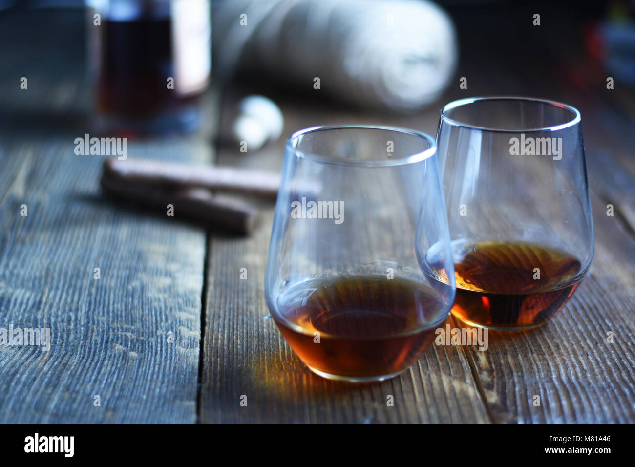 Vintage tools of Glass of rum on a rustic wooden table with cigars and ...