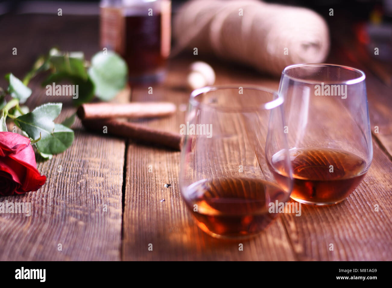 Vintage tools of Glass of rum on a rustic wooden table with cigars and ...