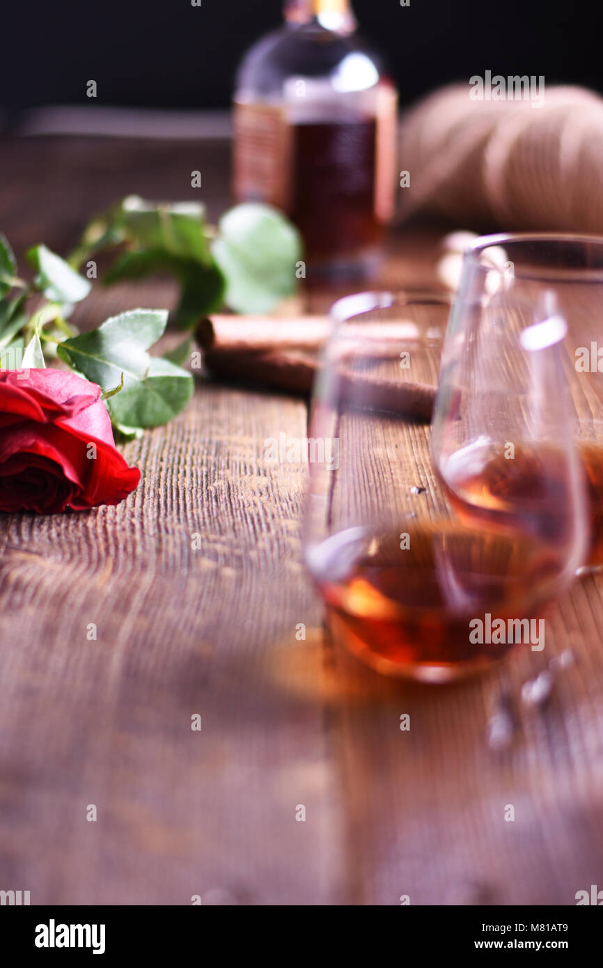 Vintage tools of Glass of rum on a rustic wooden table with cigars and ...