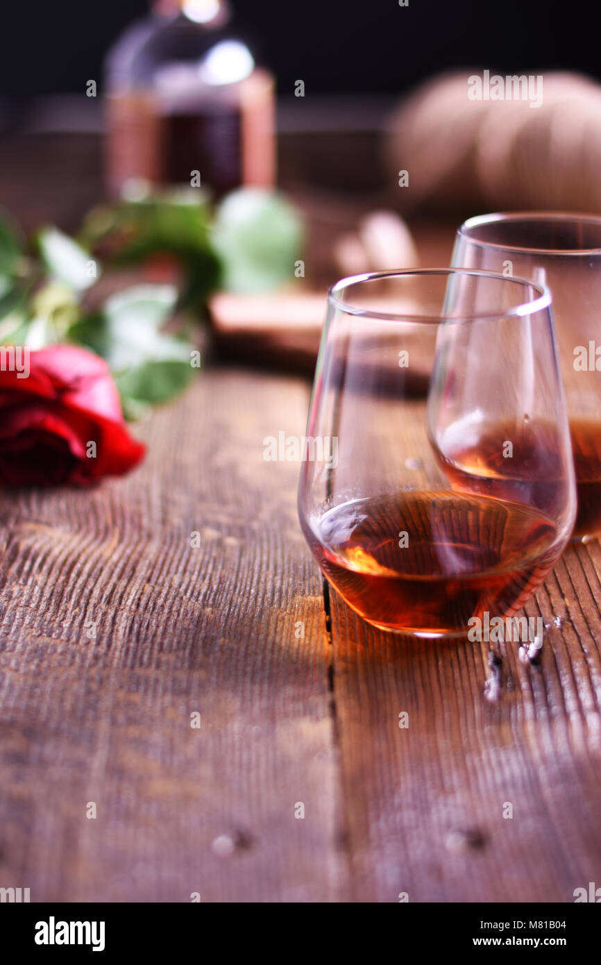 Vintage tools of Glass of rum on a rustic wooden table with cigars and ...