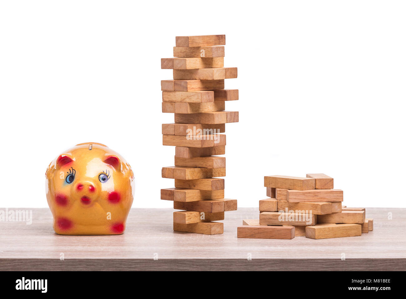Pile of blocks wood game and piggy bank on wooden table. Studio shot ...