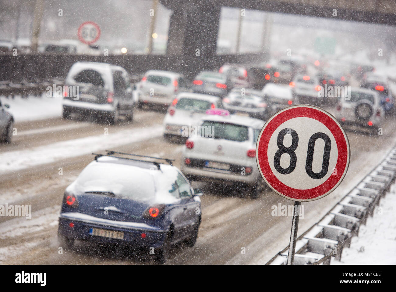 Winter traffic jam during snowstorm with poor visibility. Speed limit ...