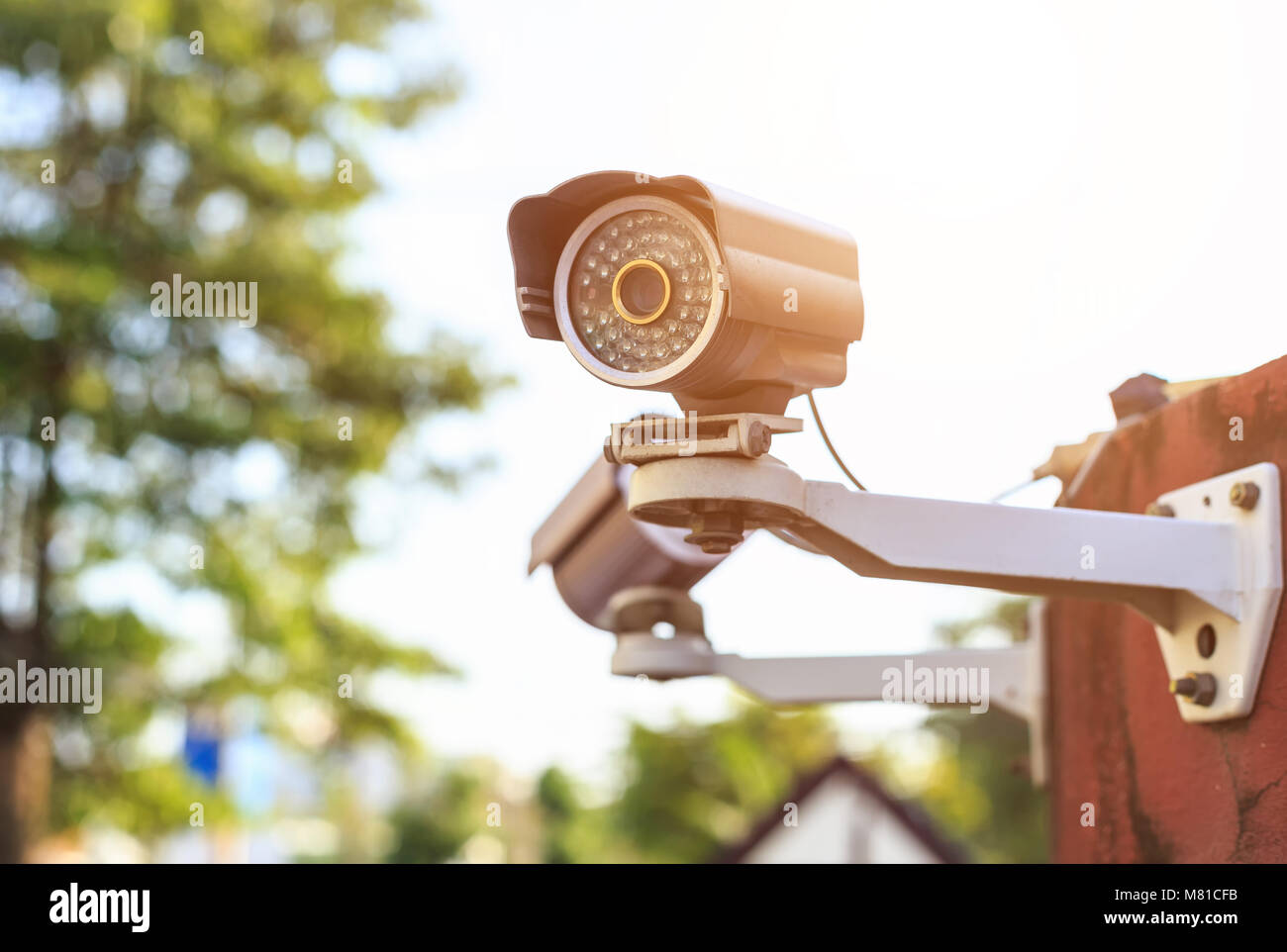 Security CCTV camera installed on wall in front of village at public ...