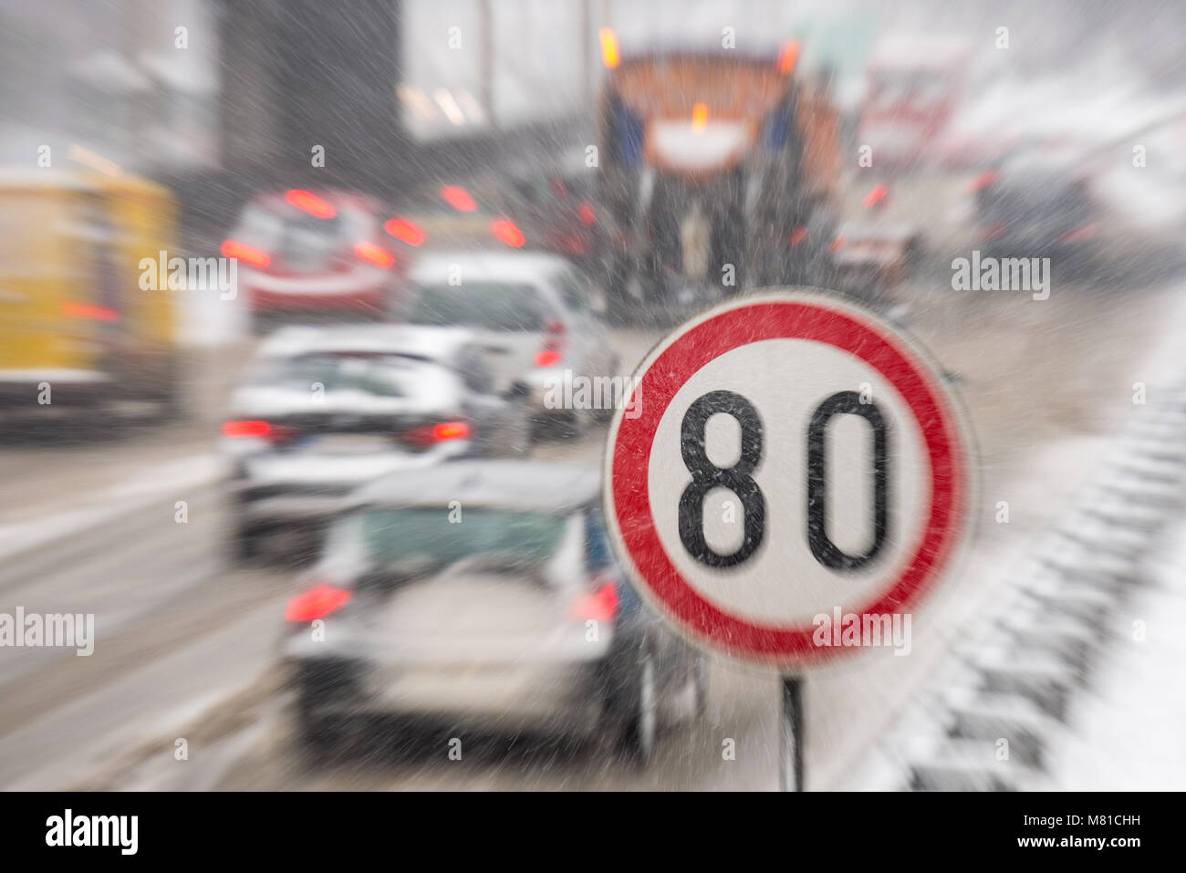 Winter traffic jam during snowstorm with poor visibility. Snow sign and ...