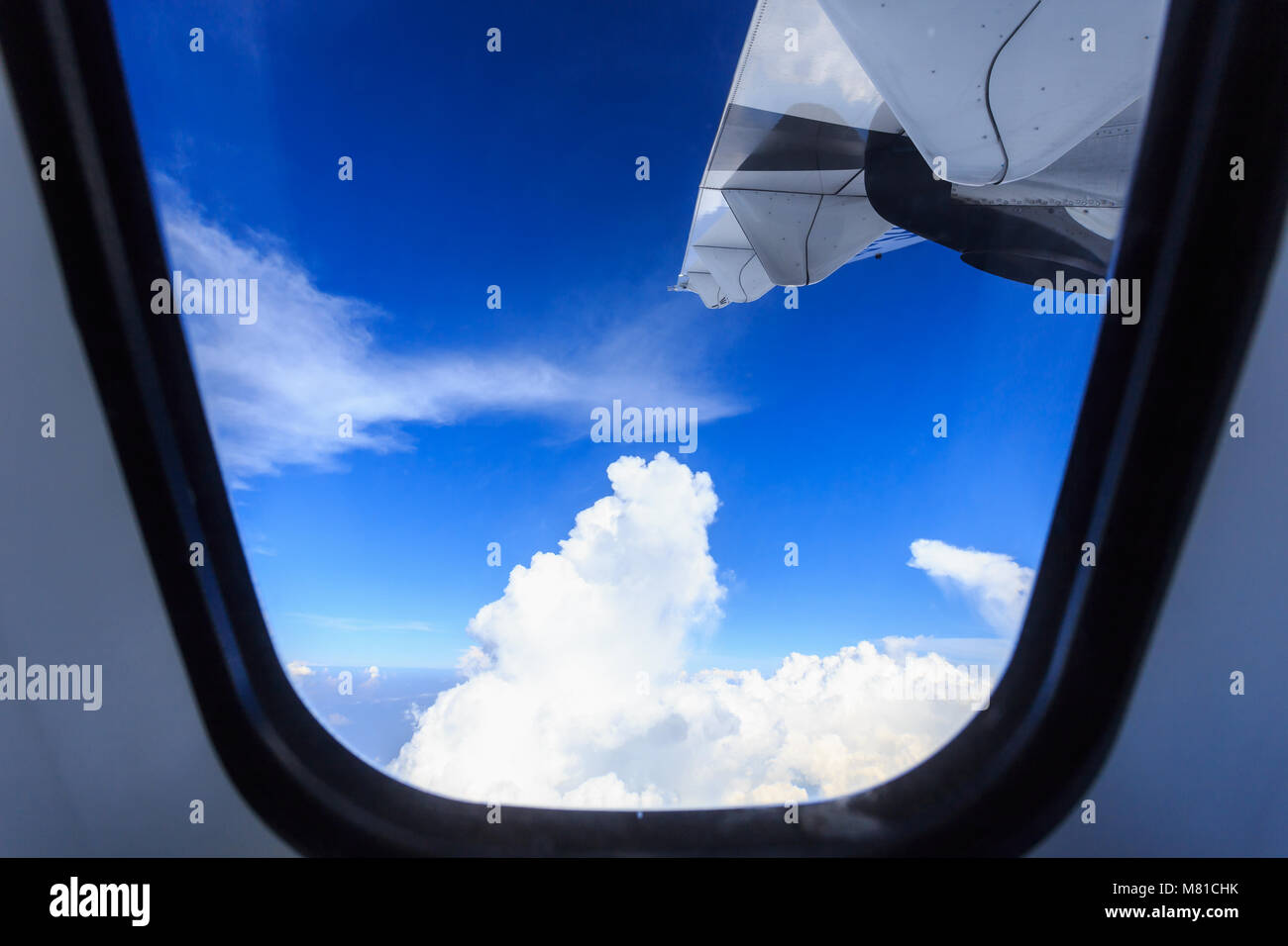 View of beautiful cloud, blue sky and wing of airplane from inside the ...