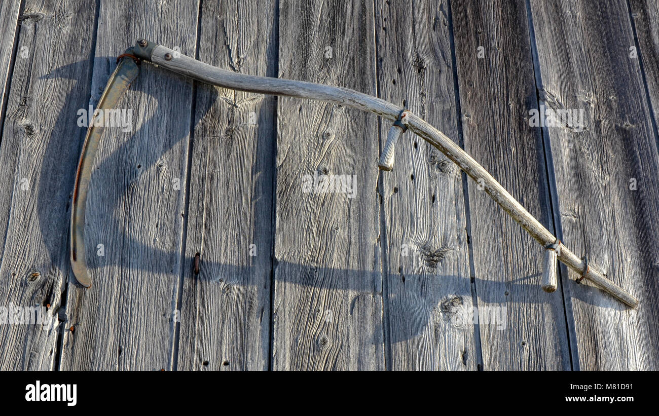 Traditional wooden hay scythe on barn wall Stock Photo - Alamy