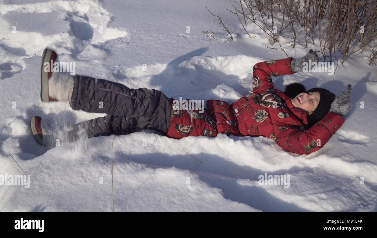 Beautiful teenage girl playing with snow in winter park Stock Photo - Alamy