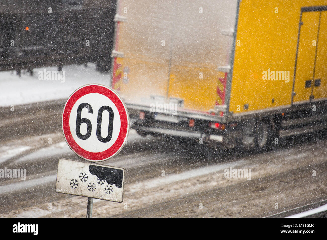 Winter traffic jam during snowstorm with poor visibility. Snow sign and ...