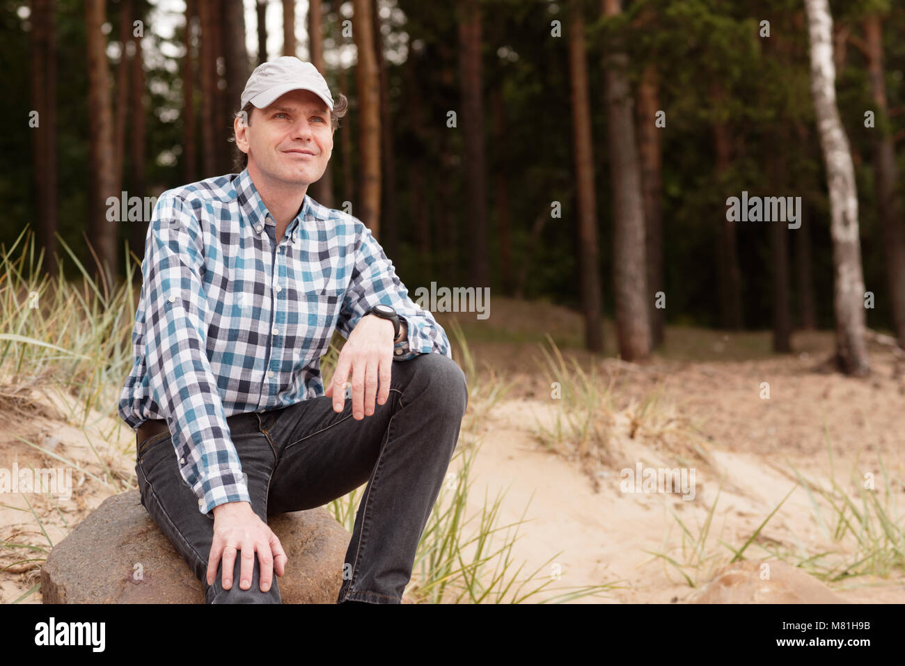 Mature man resting against pine forest Stock Photo - Alamy