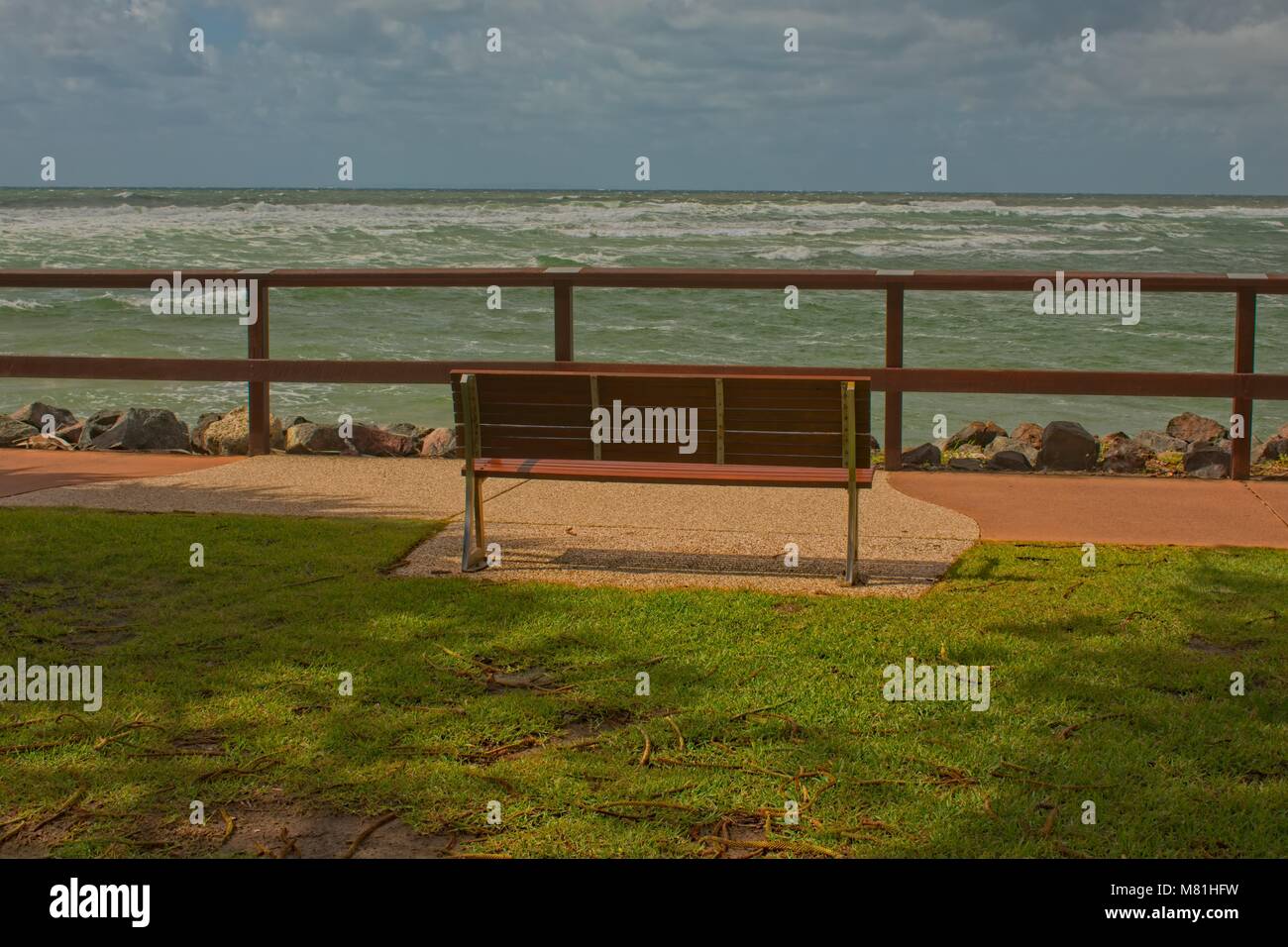 Park bench facing the ocean Stock Photo - Alamy