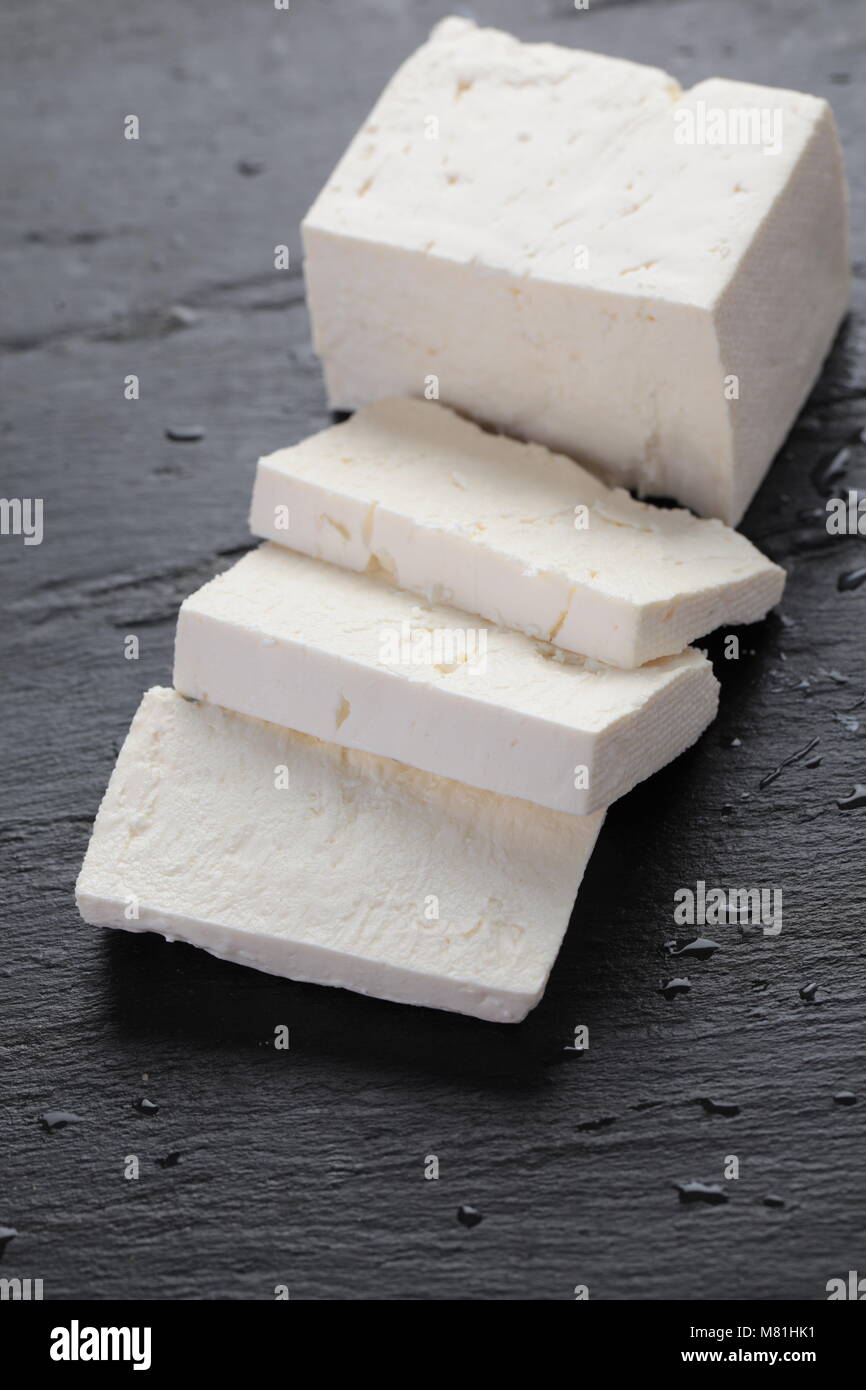 Sliced feta cheese on a slate surface Stock Photo - Alamy