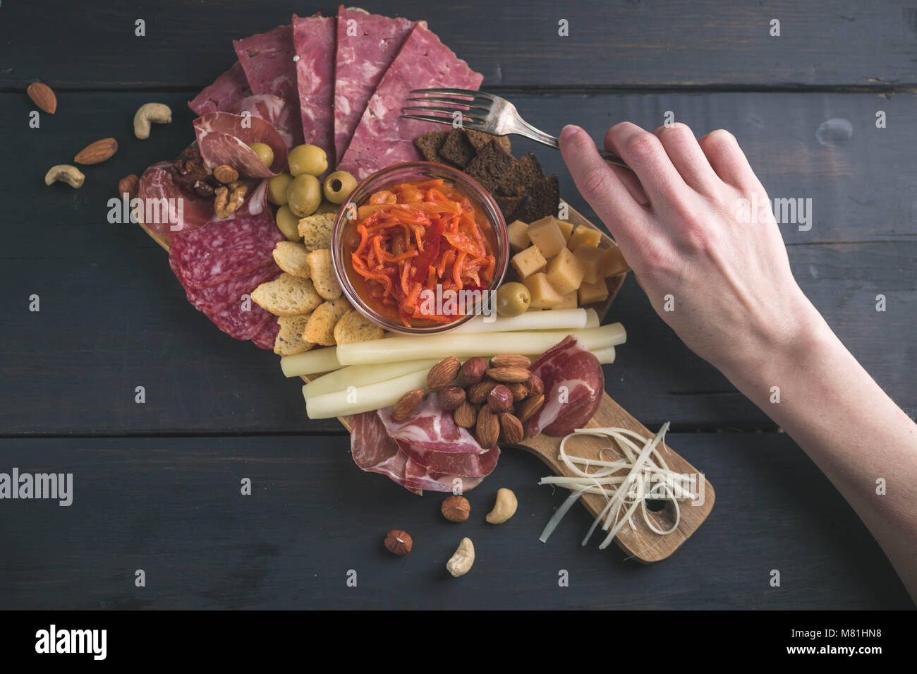 Assorted from meat and cheese on a chopping board. Smoked sausage, meat ...
