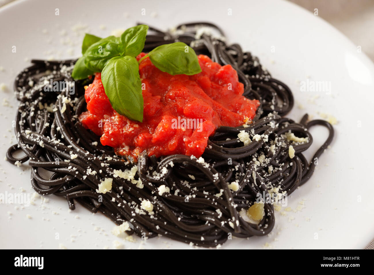 Cuttlefish ink spaghetti with Parmesan cheese and tomato sauce ...