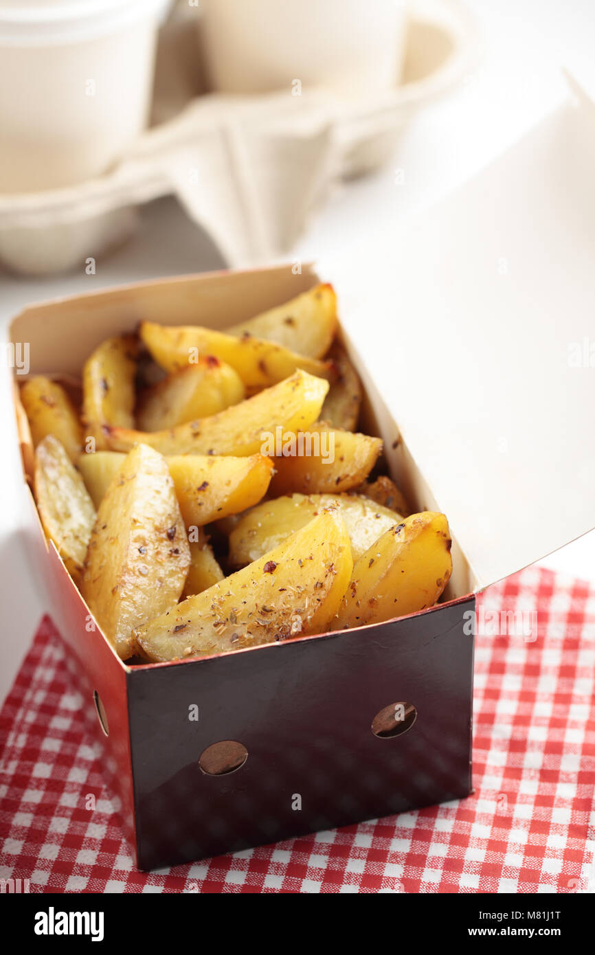 Takeout roasted potato in a paper box Stock Photo - Alamy