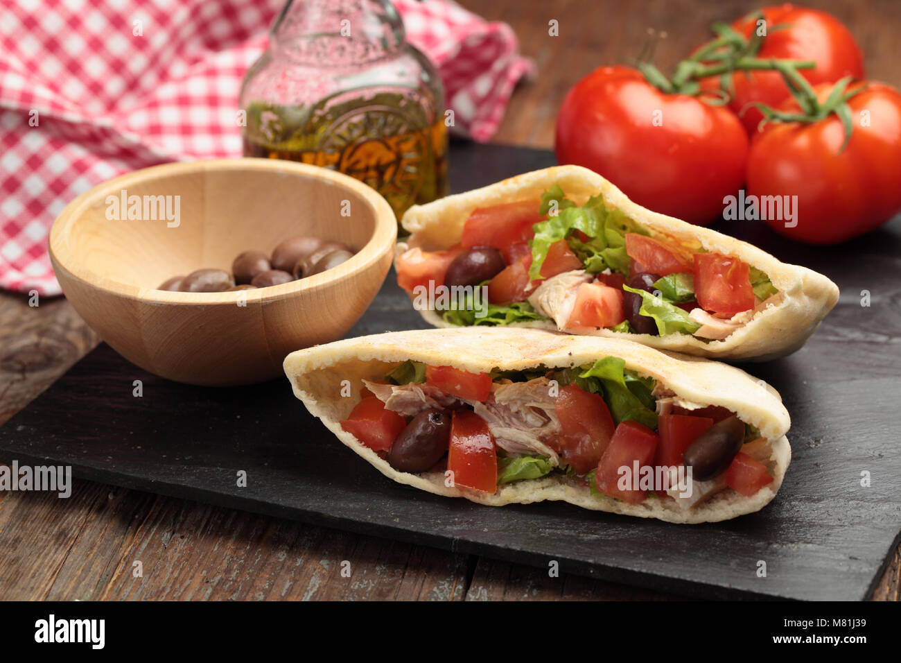 Pita bread stuffed with turkey meat, tomato, kalamata olives, and ...