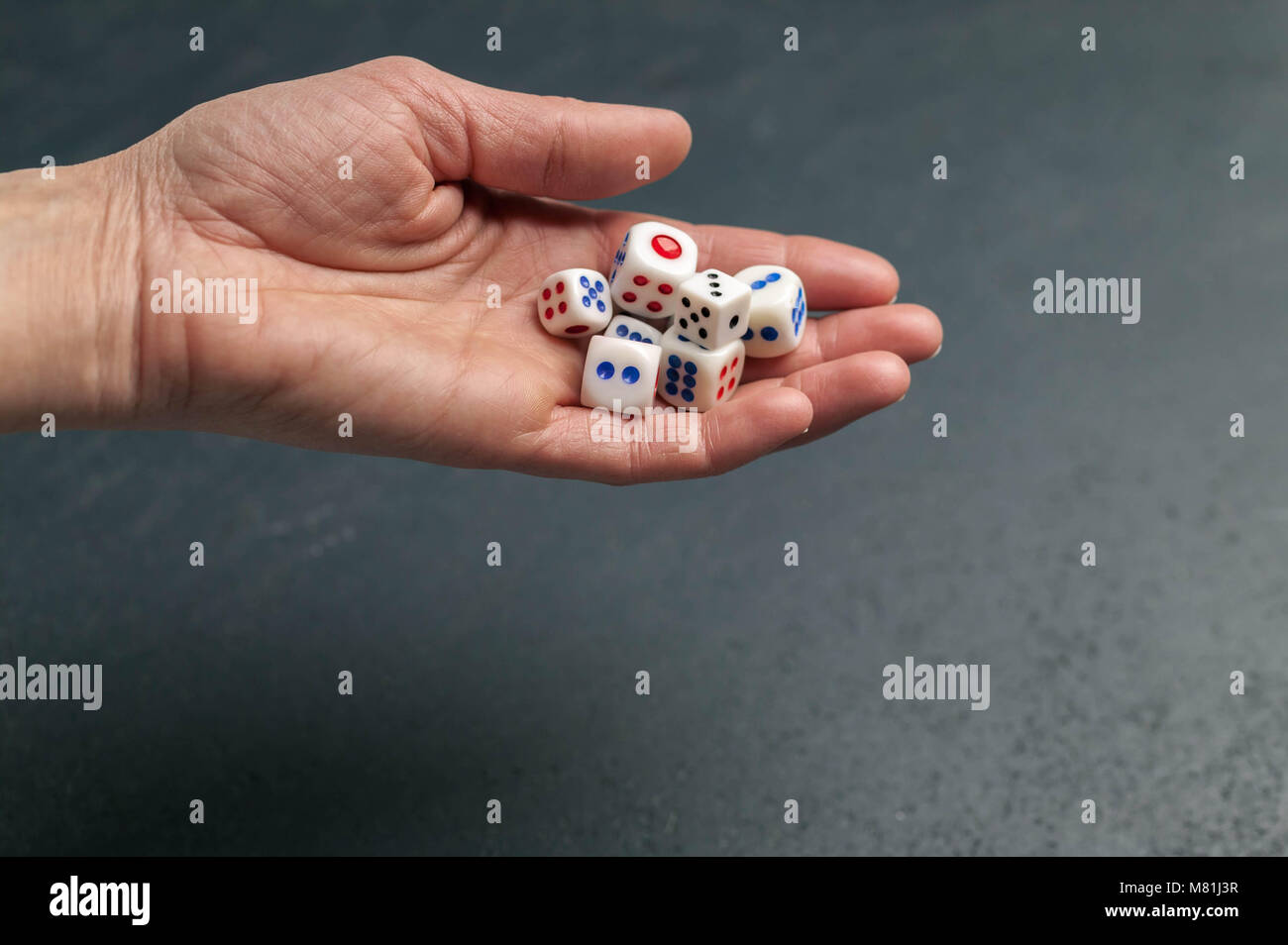 Hand with dice hi-res stock photography and images - Alamy