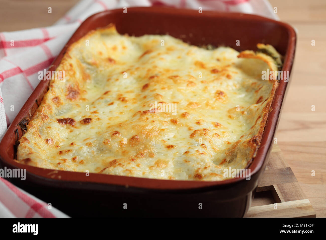 Lasagna with arugula in a baking dish Stock Photo - Alamy