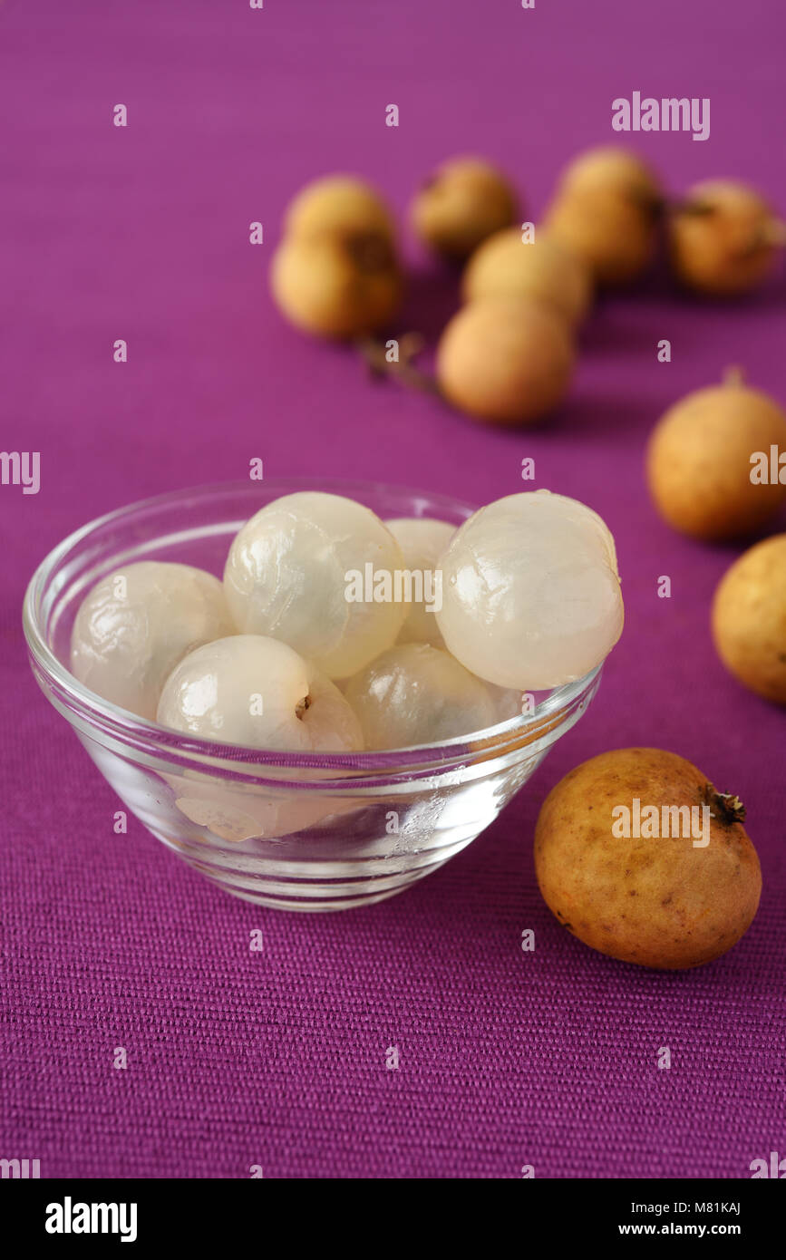 Raw and peeled fruits of longan, literally Dragon Eye Stock Photo - Alamy